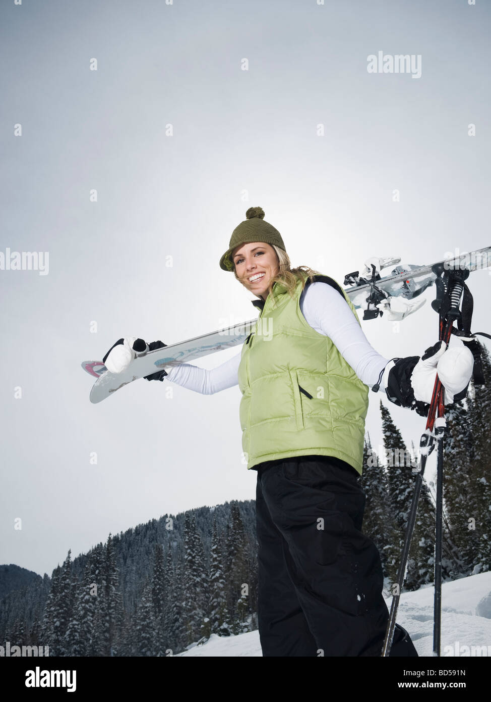 A downhill skier carrying skis Stock Photo - Alamy