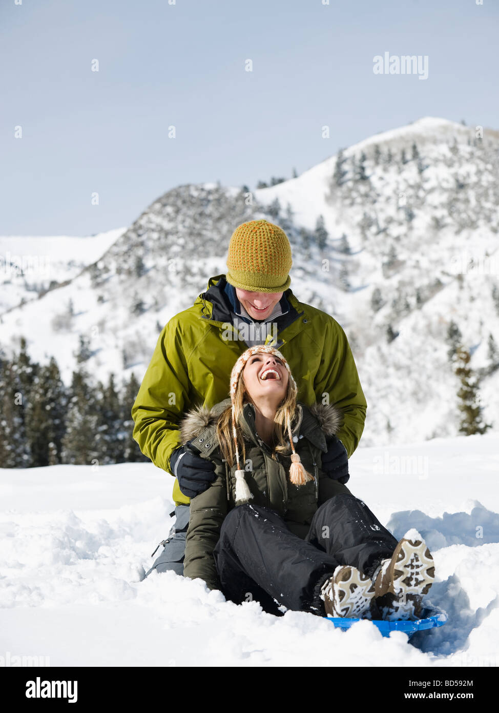 A couple sledding Stock Photo - Alamy