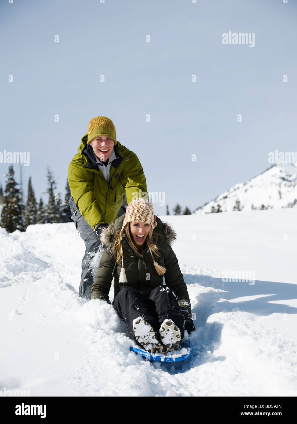 Young couples tobogganing hi-res stock photography and images - Alamy