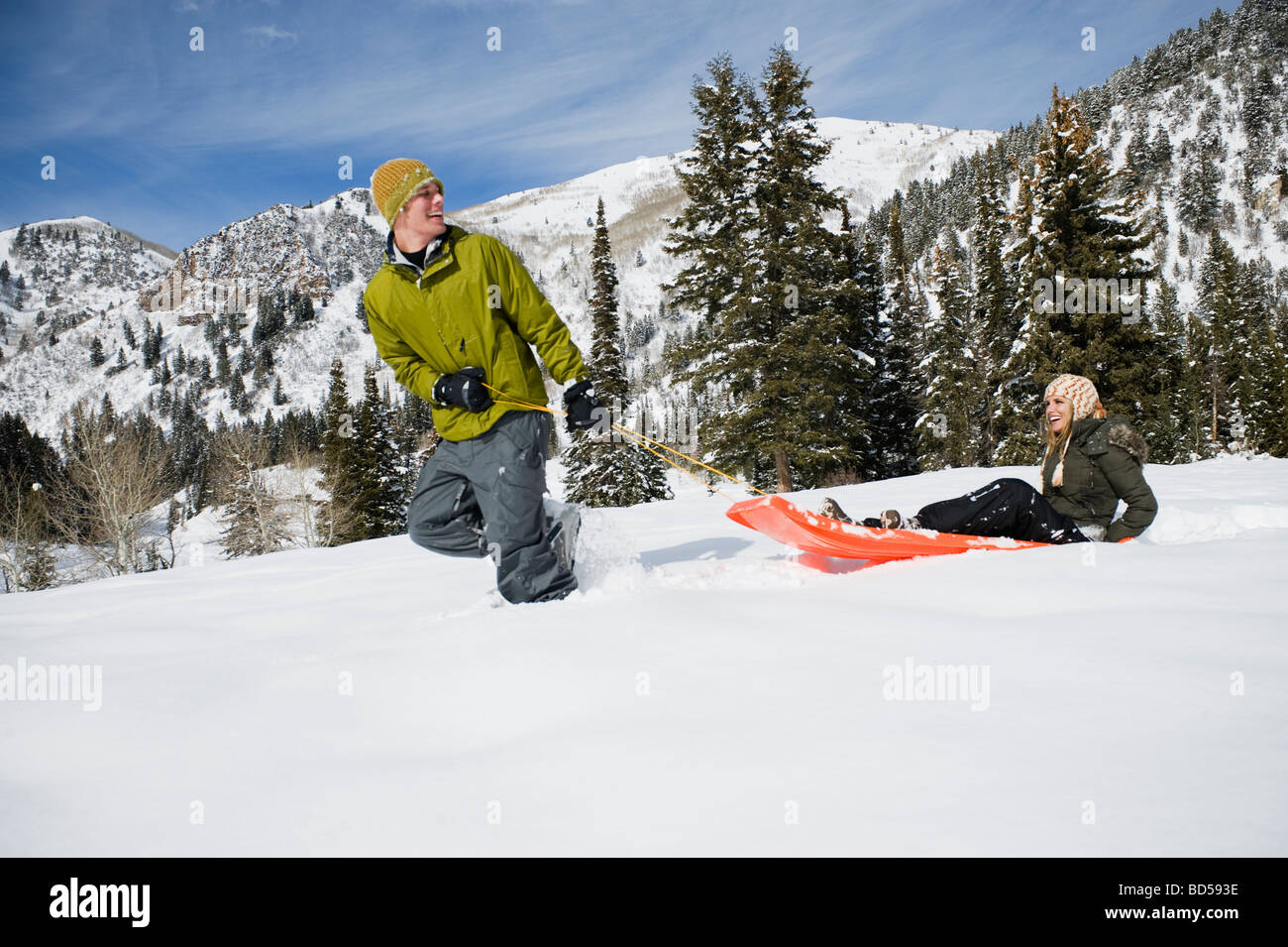 A couple sledding Stock Photo - Alamy