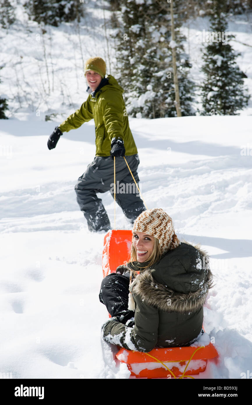A couple sledding Stock Photo - Alamy