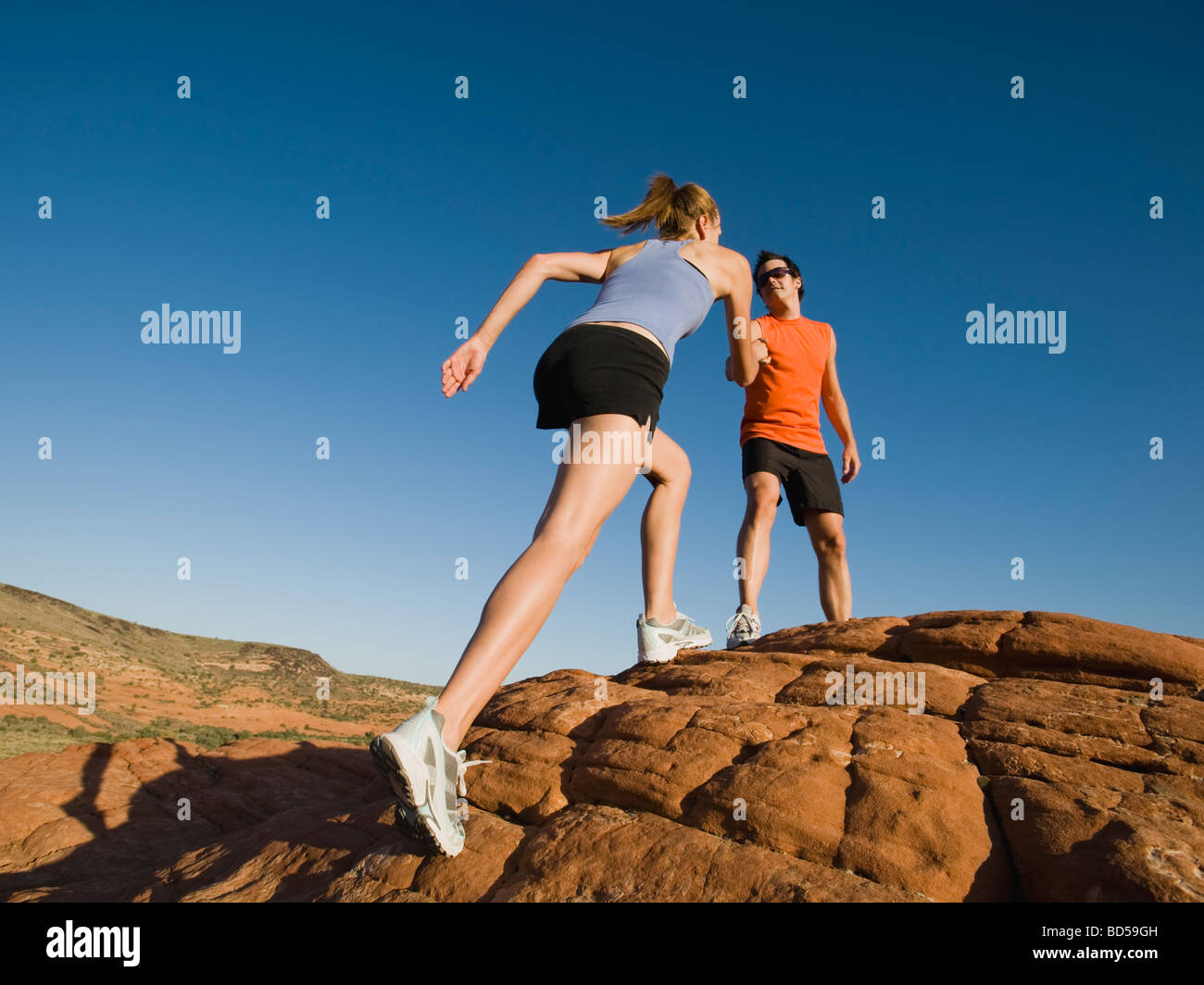Female runner jumping rocks hi-res stock photography and images - Alamy
