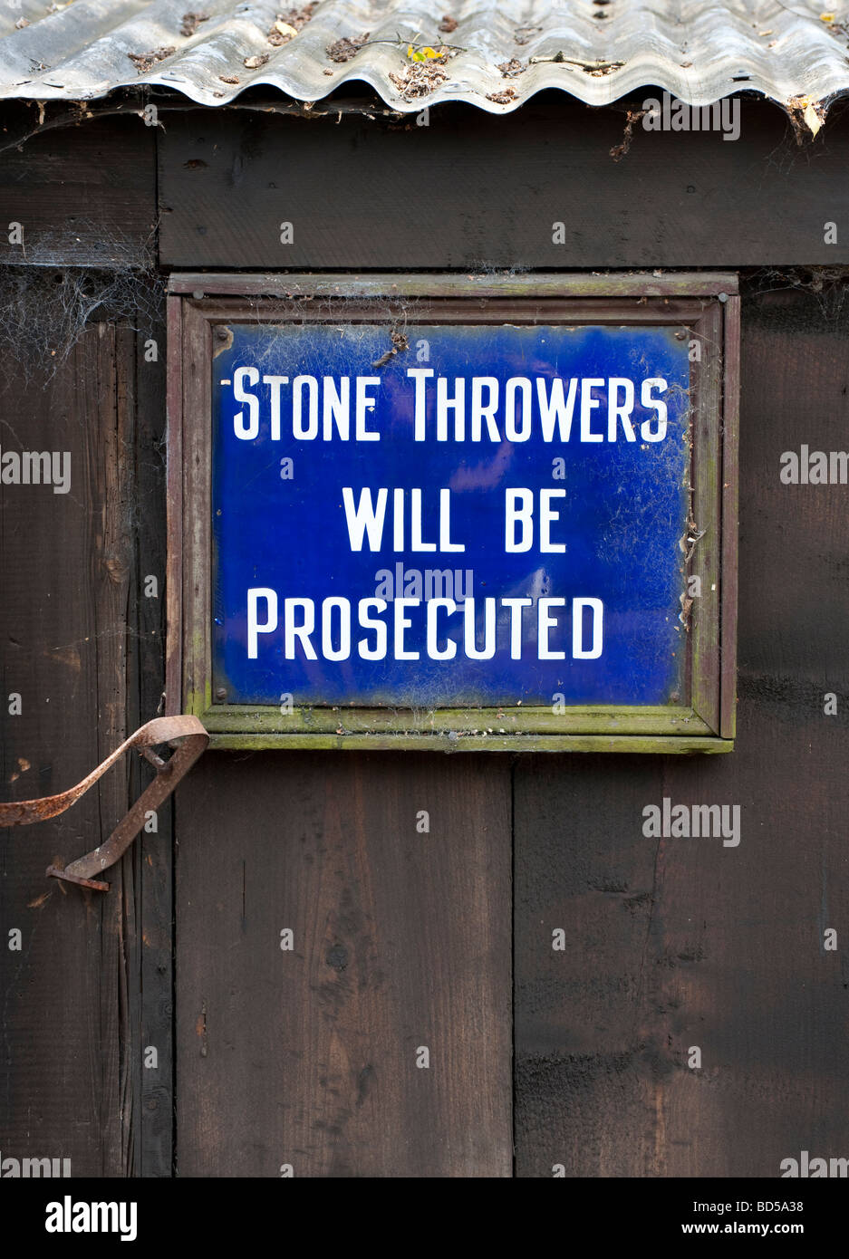 Old Stone Throwers Will Be Prosecuted sign Stock Photo - Alamy