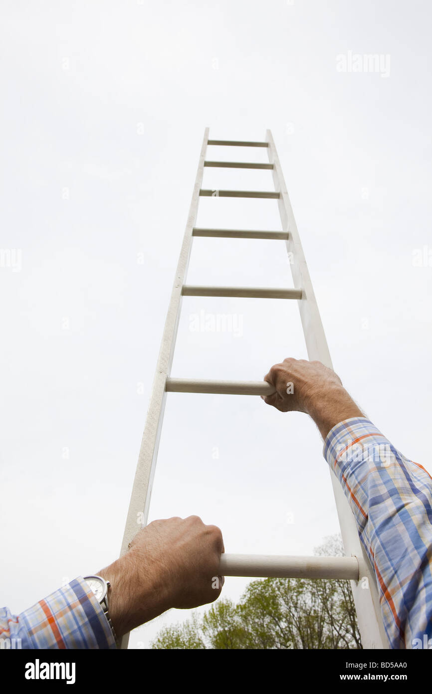 Hands on a ladder outdoors Stock Photo - Alamy