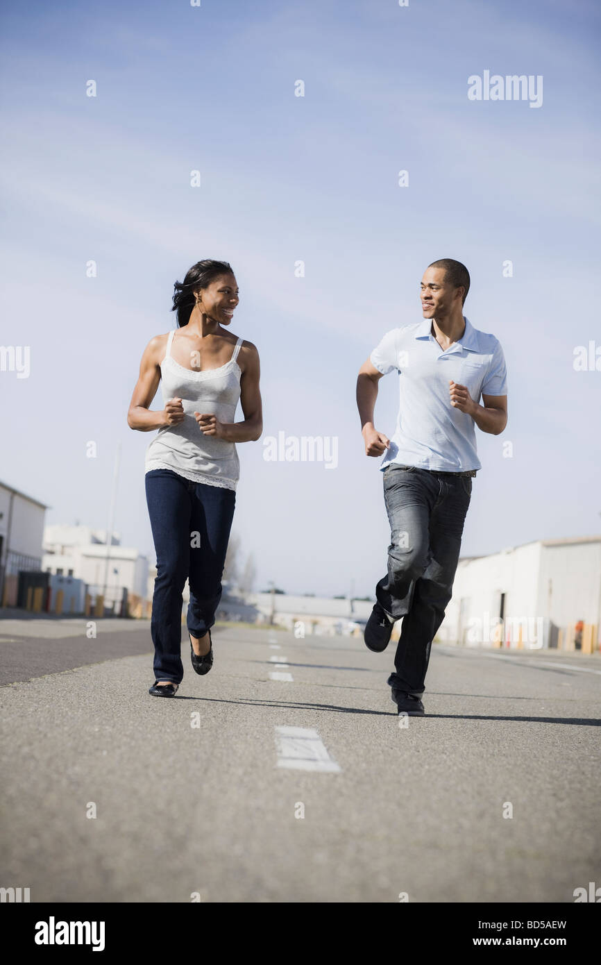 A couple running on road outdoors Stock Photo - Alamy