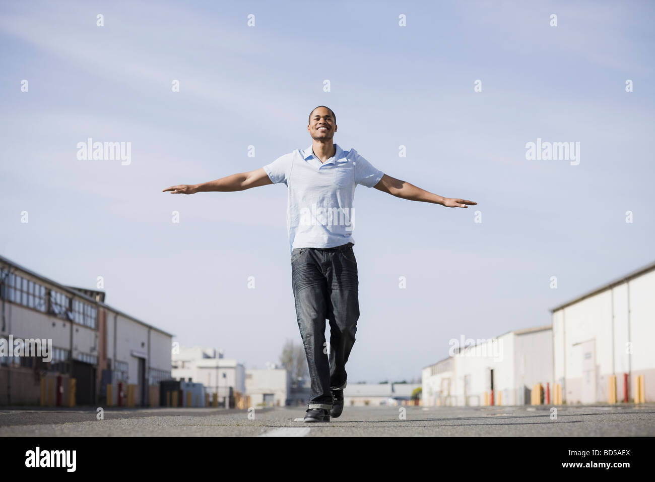 A man walking the line on a road Stock Photo - Alamy