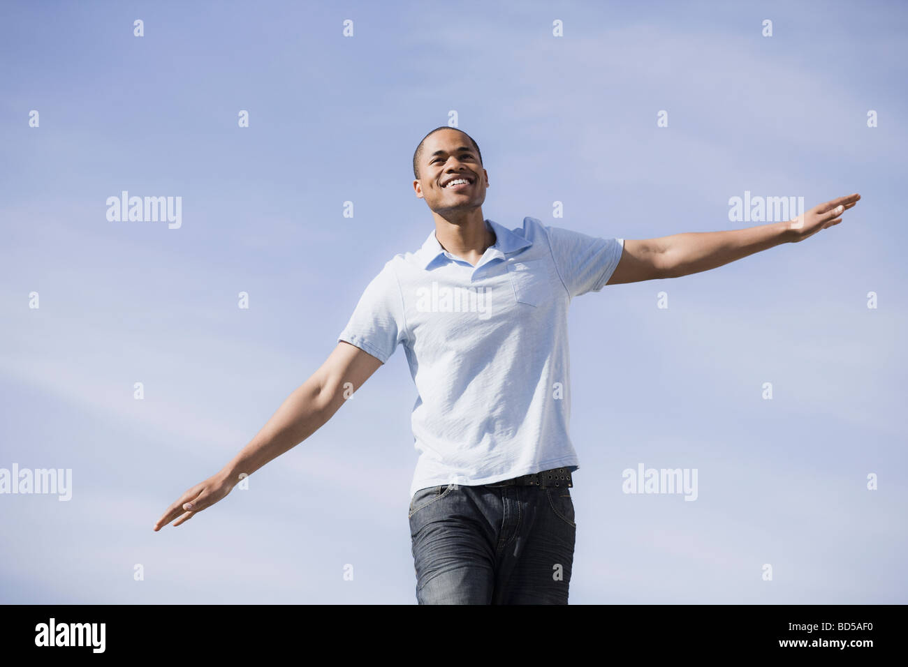 A man outdoors with arms out Stock Photo - Alamy