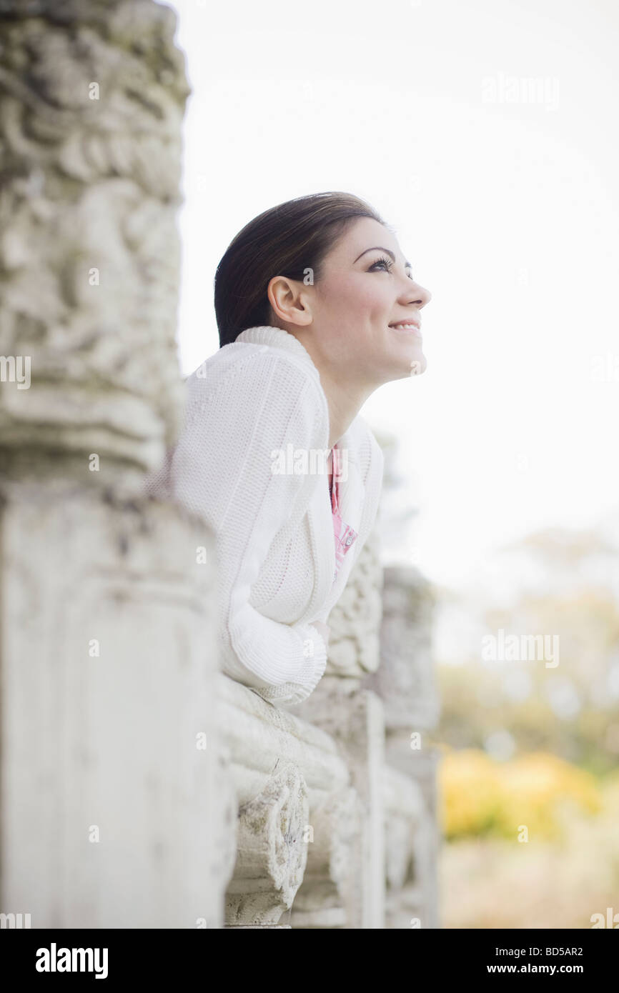 A woman leaning on a railing outdoors Stock Photo - Alamy