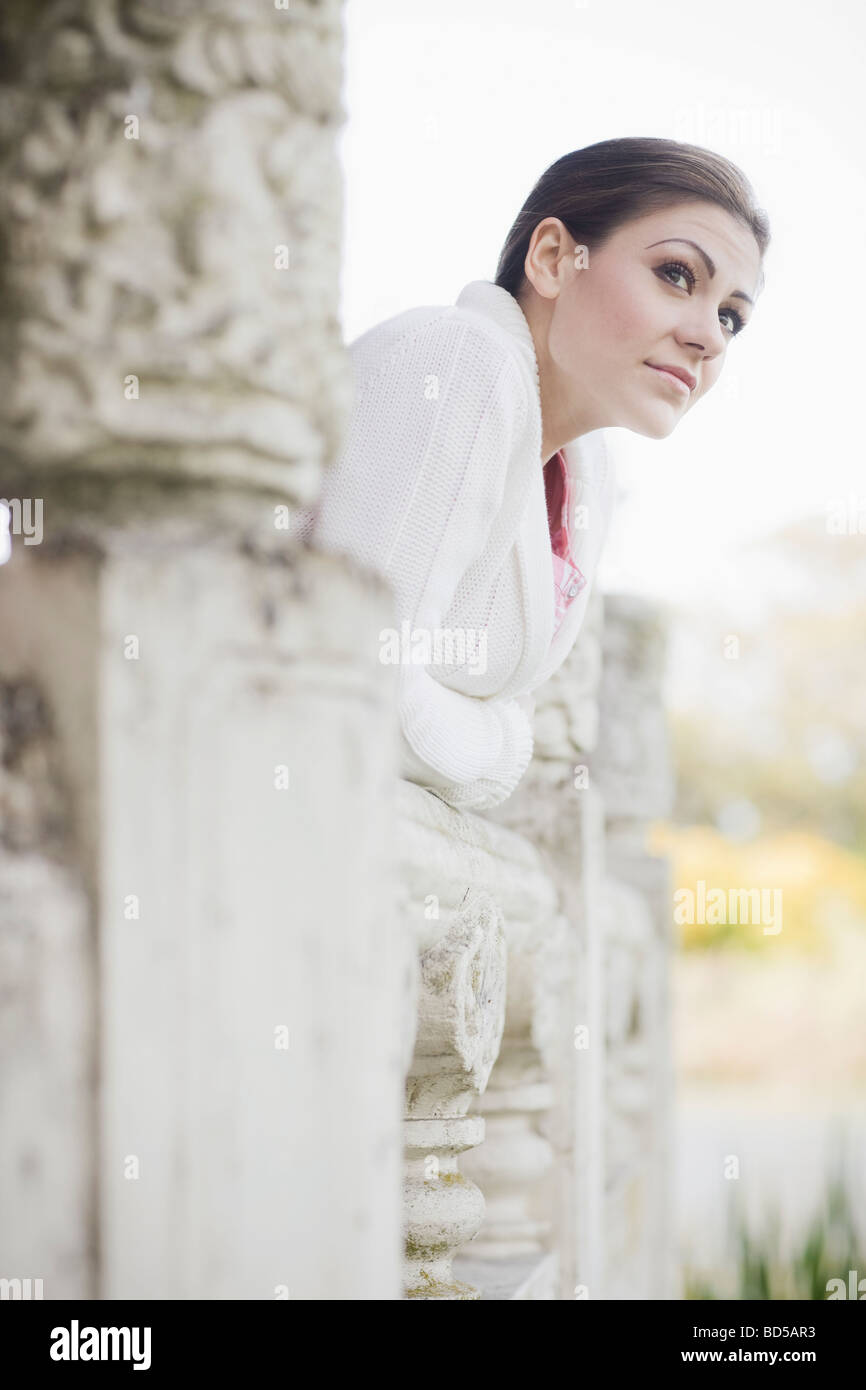 A woman leaning on a railing outdoors Stock Photo - Alamy
