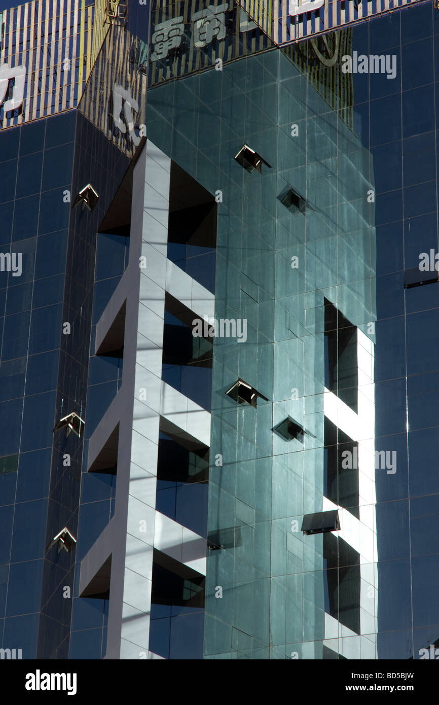 reflections in new modern chinese office block in the town of tsetang ...