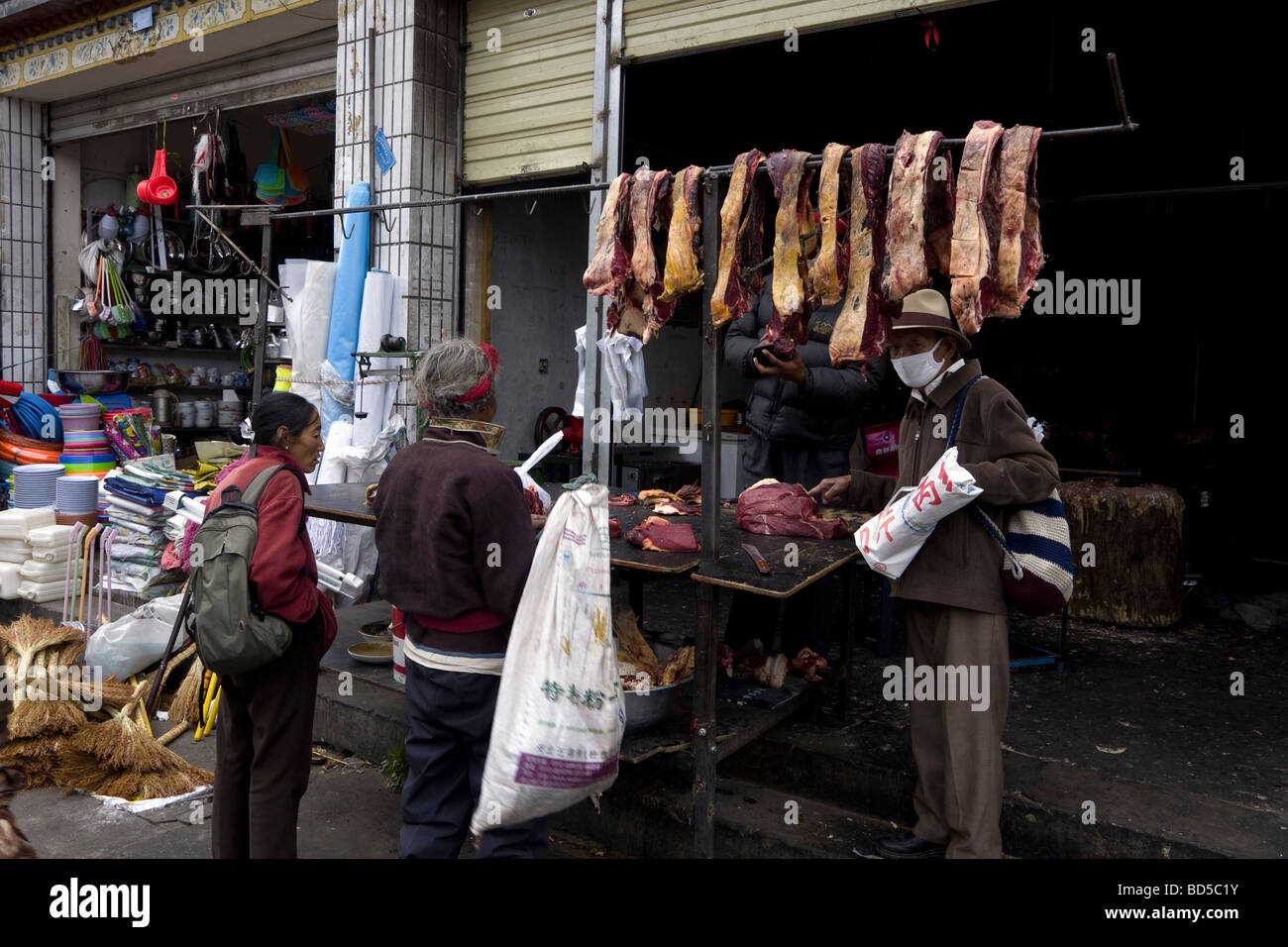 customers at traditional back street butchers shop in the old town ...
