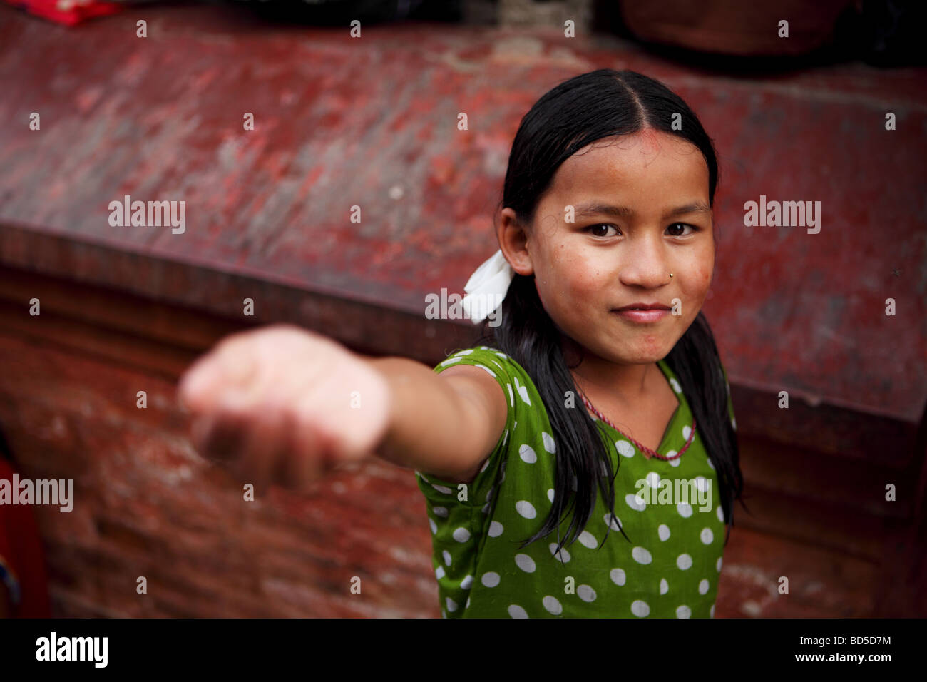 Asian girl holding out hand Stock Photo - Alamy