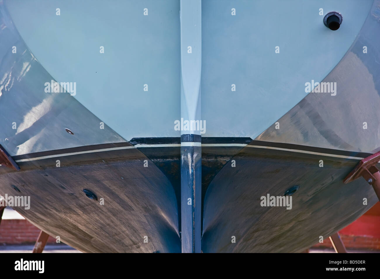 Photograph of the stern of a blue boat, showing the rudder and exhaust ...