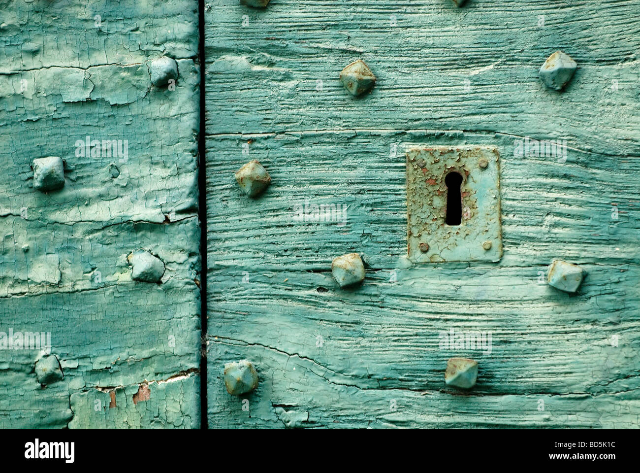 Ancient rusty key hole in turquoise blue studded timber door Cortona ...