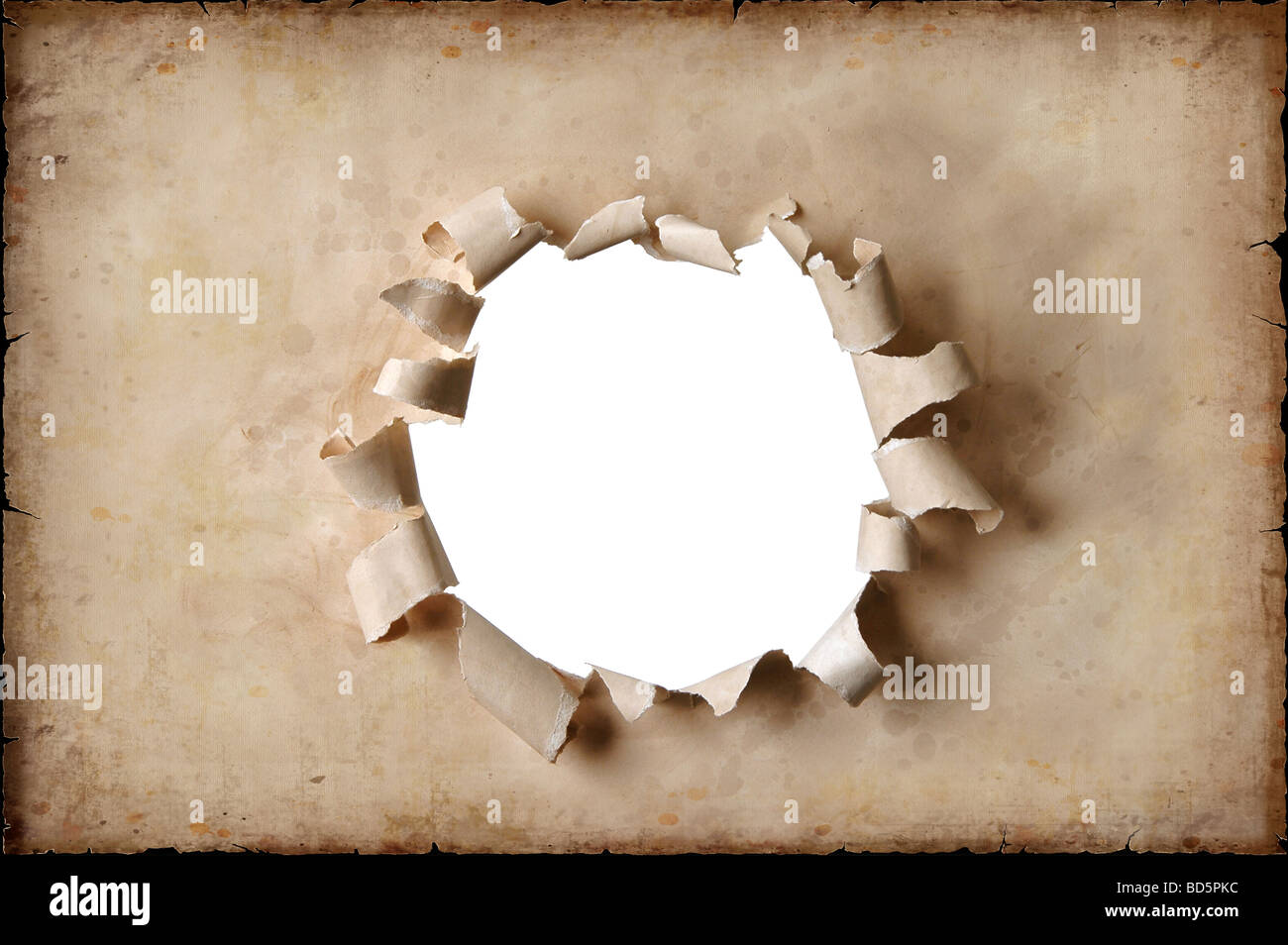 Vintage paper with a hole torn in the middle Stock Photo - Alamy
