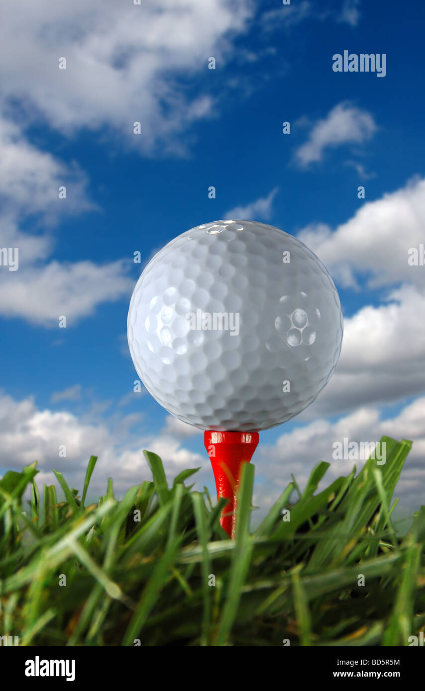 Golf ball and tee over a blue sky and clouds Stock Photo - Alamy