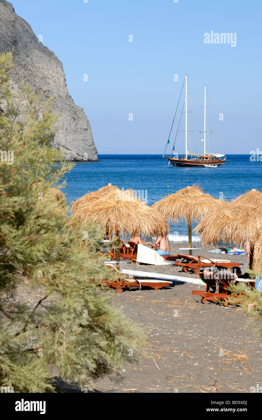 Perissa beach consist of black sand, which gets very hot during the ...