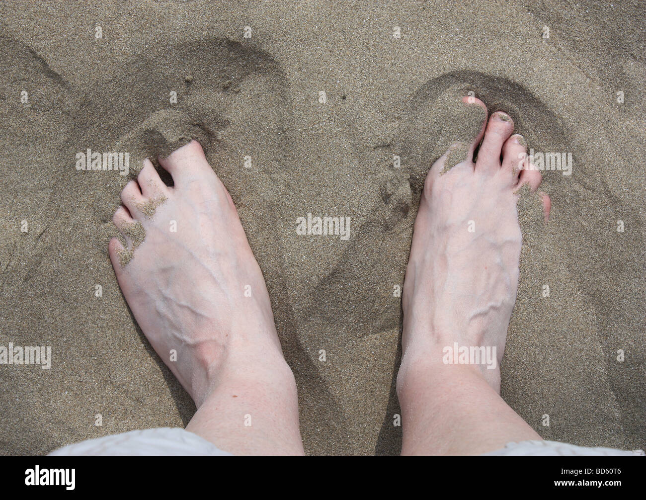 Feet in sand Stock Photo - Alamy