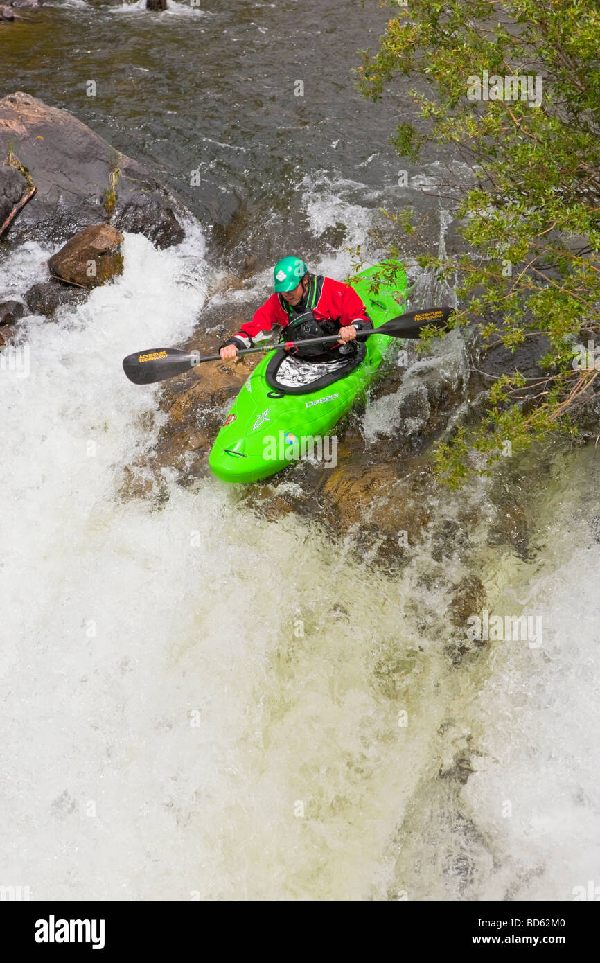 Kayakers in creek boat kayaks jumping falls on Clear Creek above Empire ...