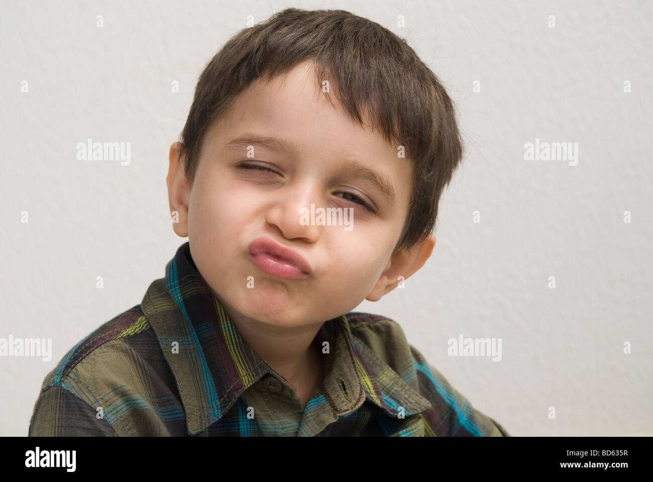 Young boy pulling a funny face Stock Photo - Alamy