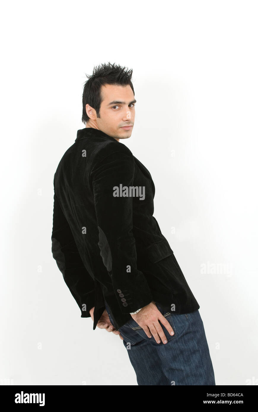 Young man looking over shoulder Stock Photo - Alamy