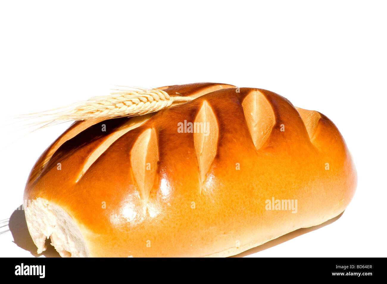Close-up of a loaf of bread and a wheat stalk on white background Stock ...
