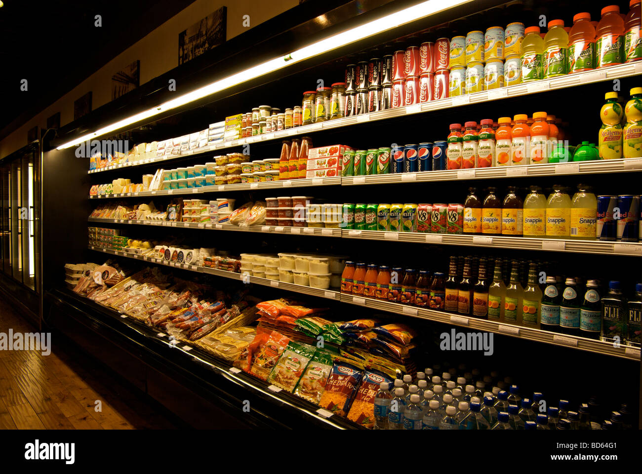 Upright cooler display case with cold drinks cheeses packaged meats ...