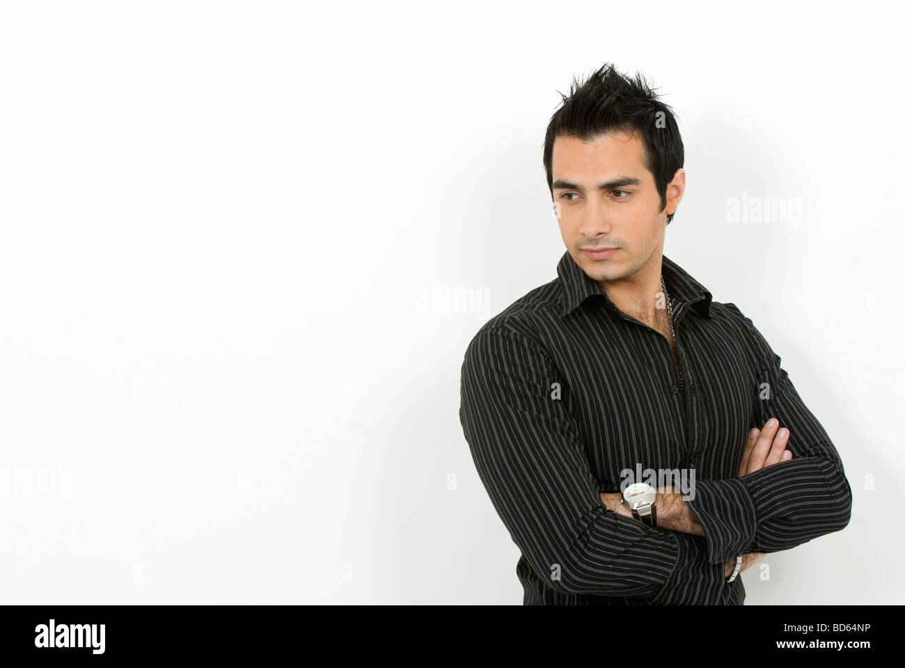 Young man arms folded Stock Photo - Alamy