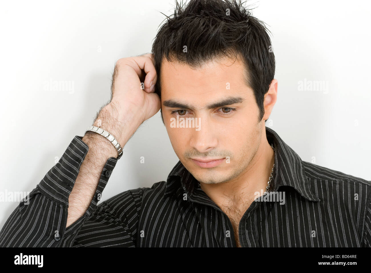 Young man hand on head Stock Photo - Alamy