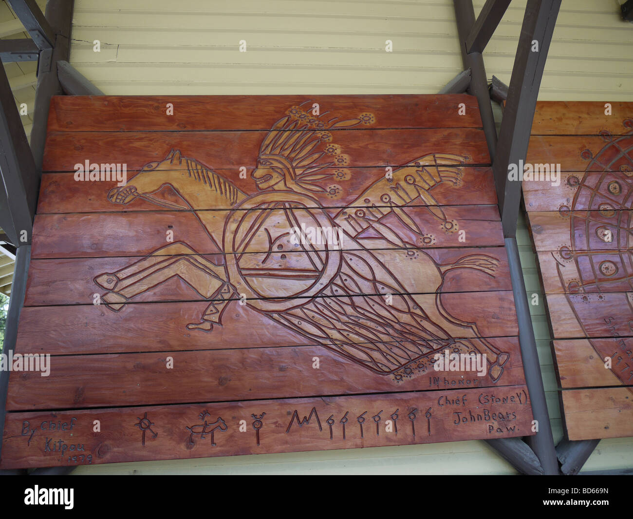 Wooden carved panel depicting horse and rider outside first Nations ...