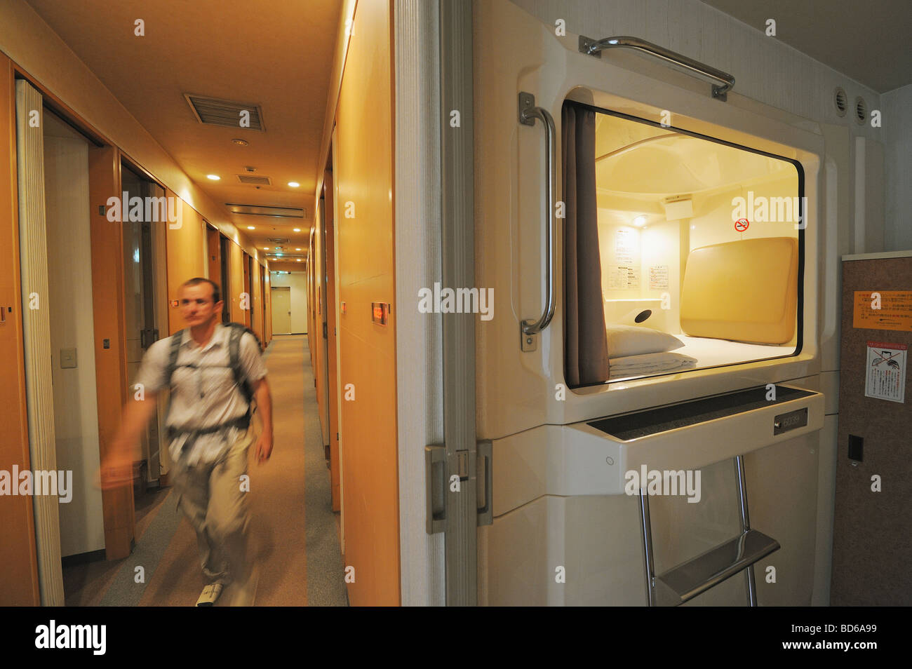 Man walking in hotel corridor Stock Photo - Alamy
