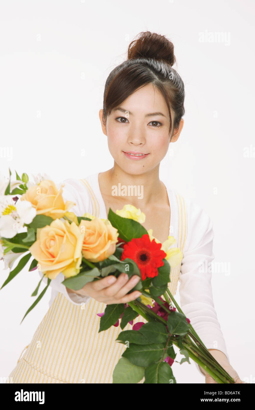 Woman presenting a bunch of flowers Stock Photo - Alamy