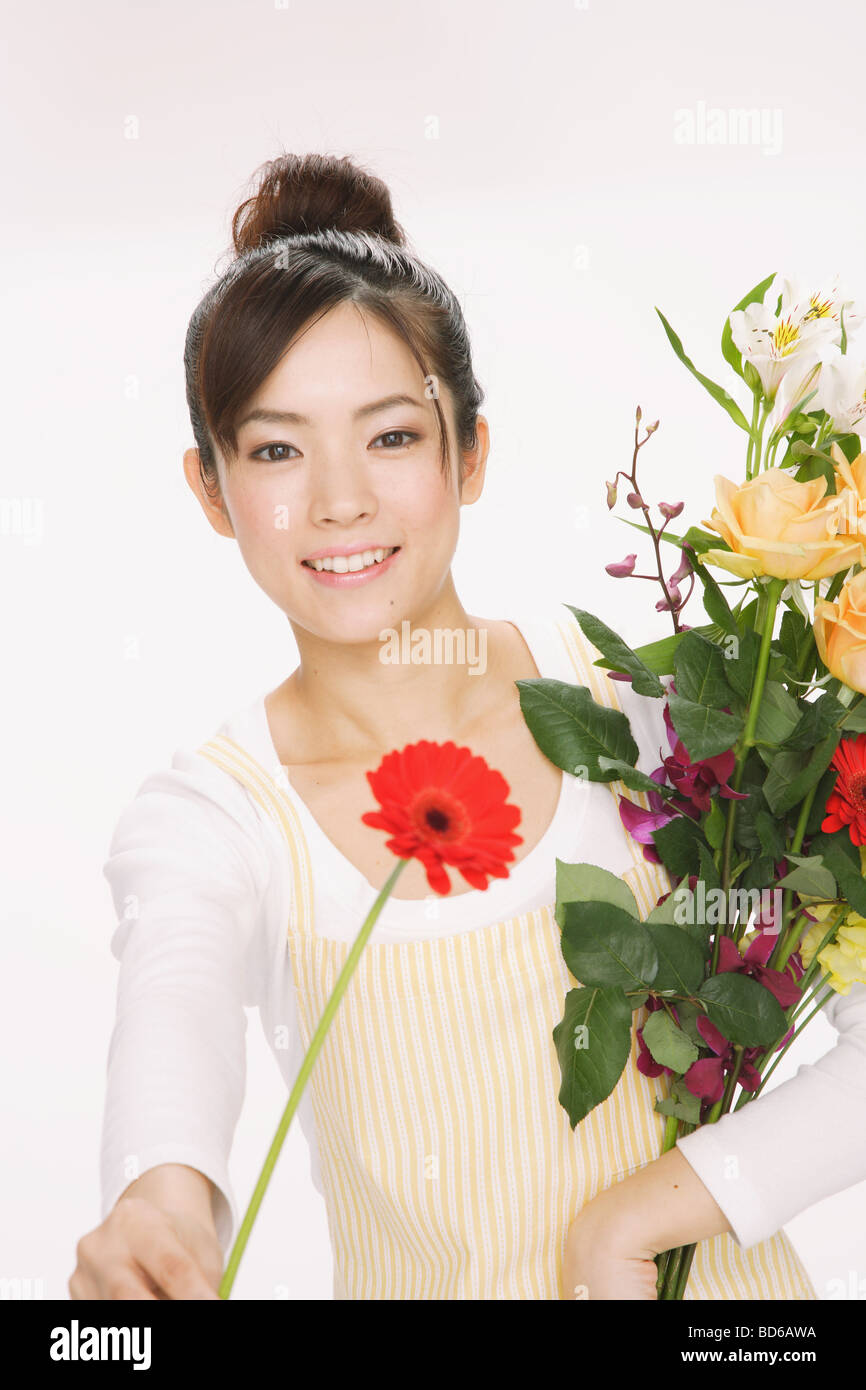 Young attractive woman giving a flower Stock Photo - Alamy