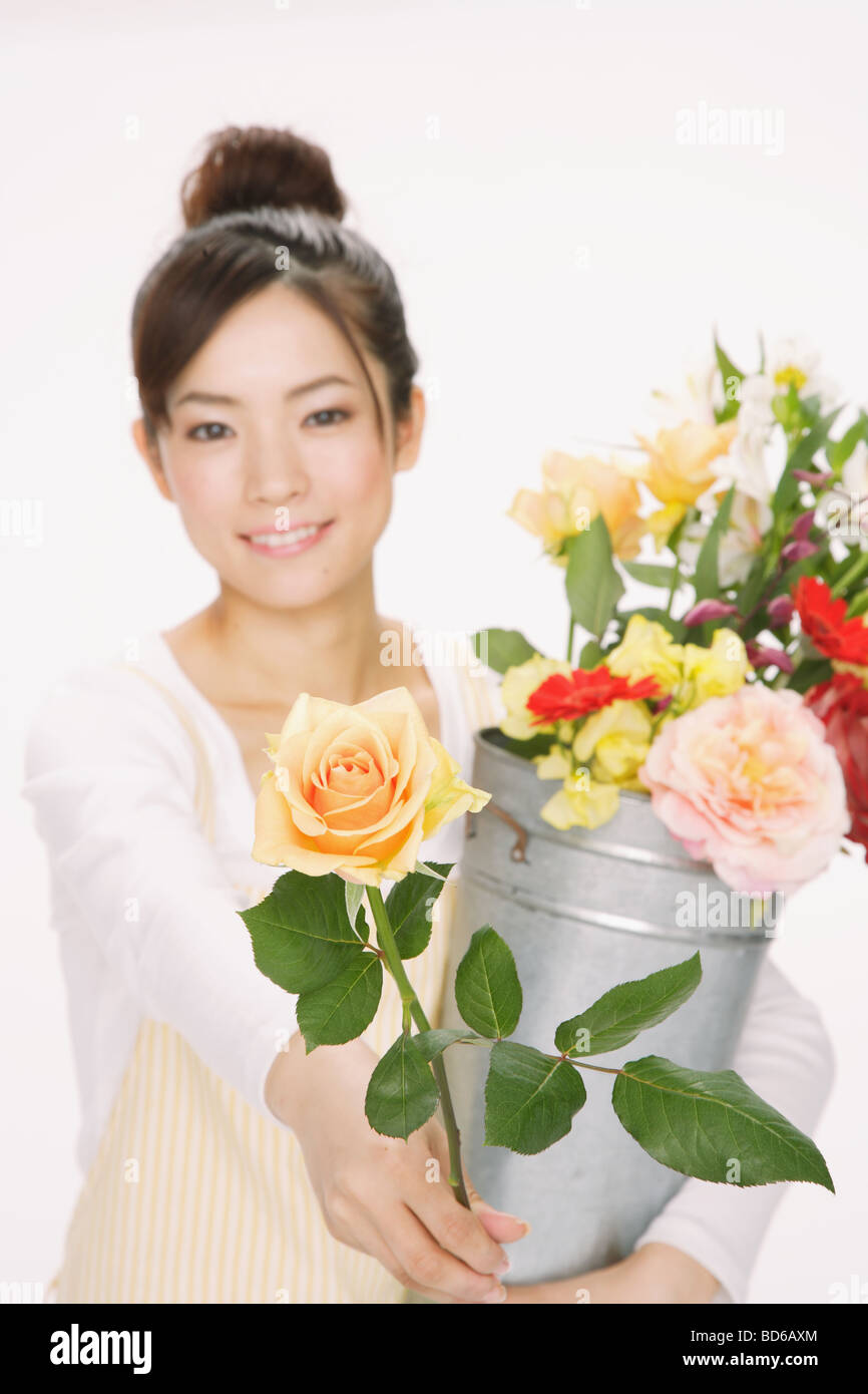 Young smiling women giving flower Stock Photo - Alamy