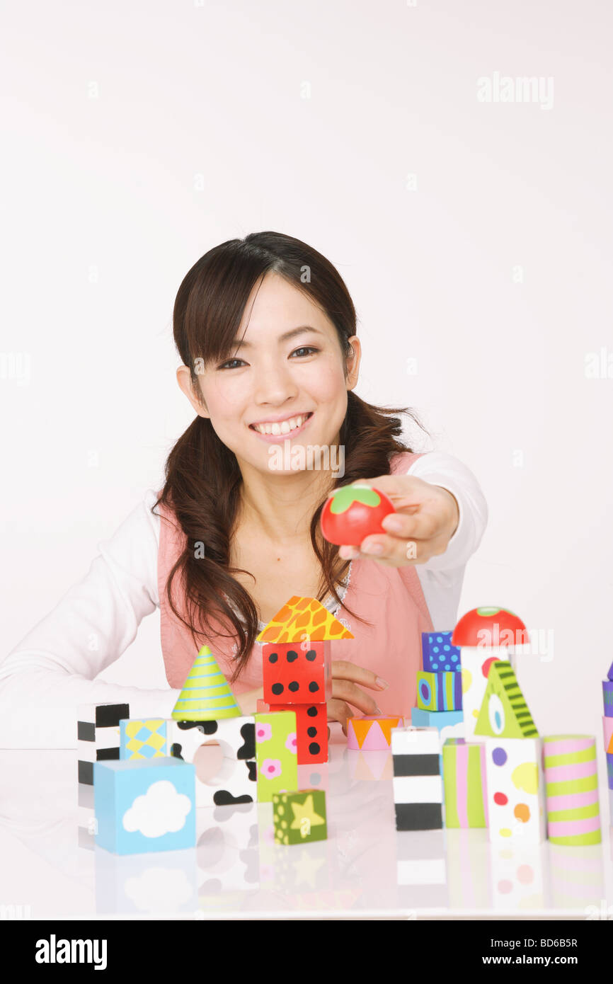 Young woman showing blocks Stock Photo - Alamy
