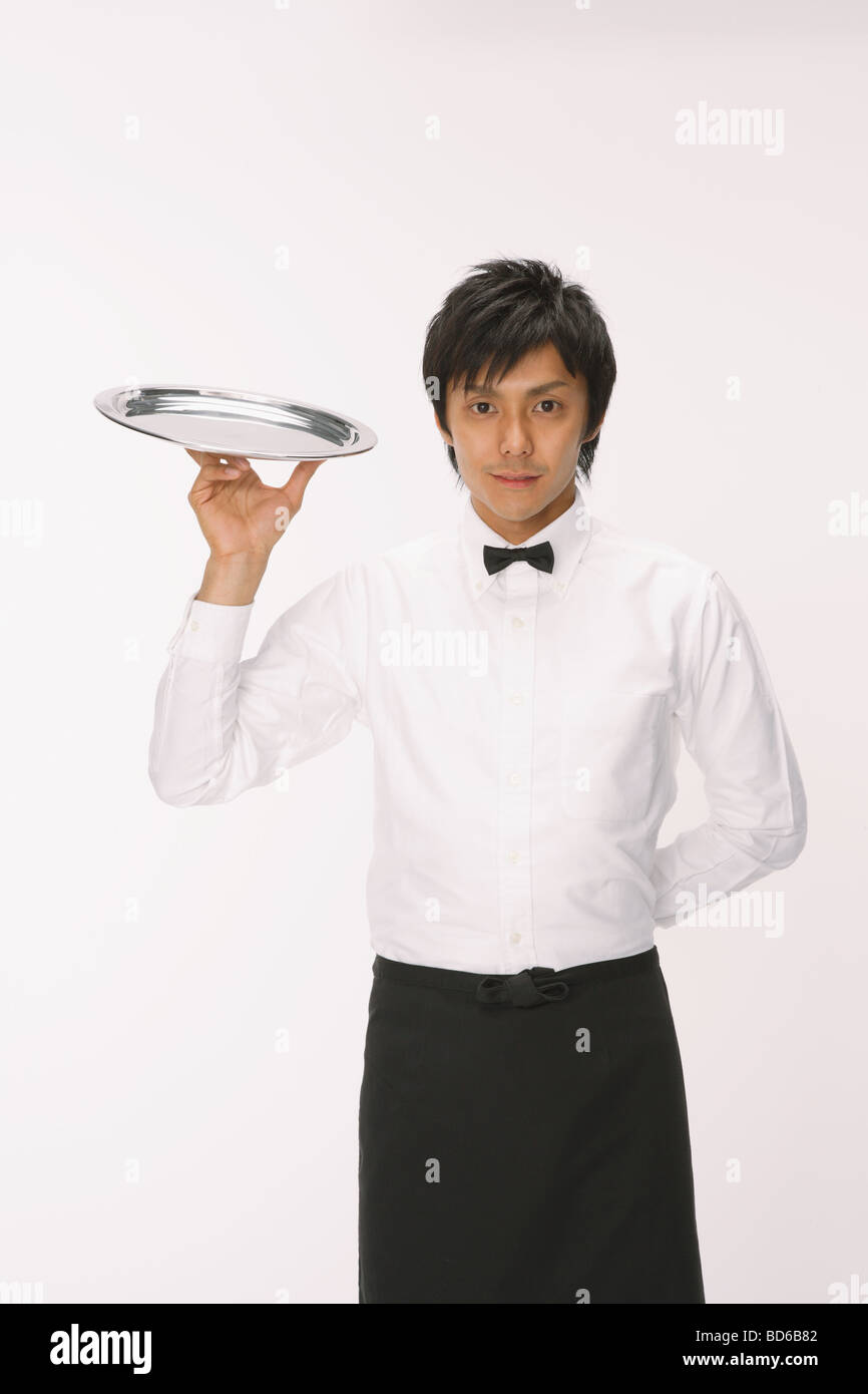 Waiter holding tray in his hand Stock Photo - Alamy