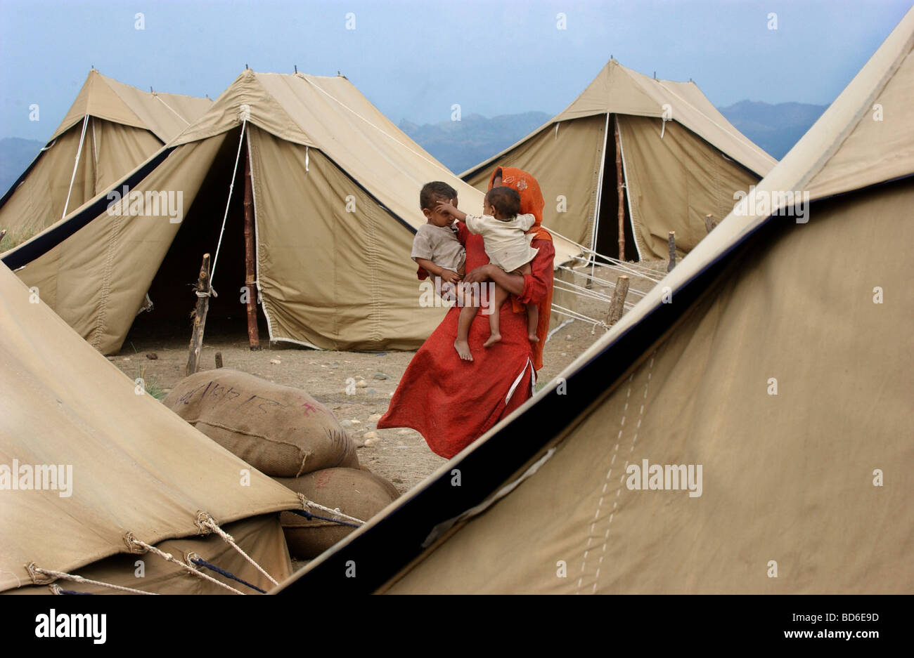Ratno Devi and her two sons who were forced to migrate from their home ...