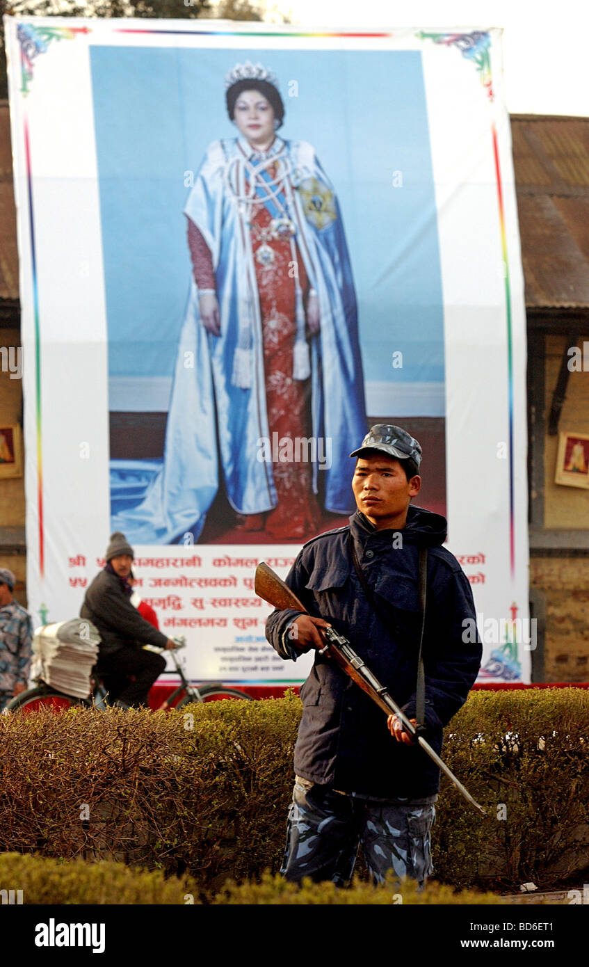 A soldier stands guard in front of a poster of Queen Komal as thousands ...
