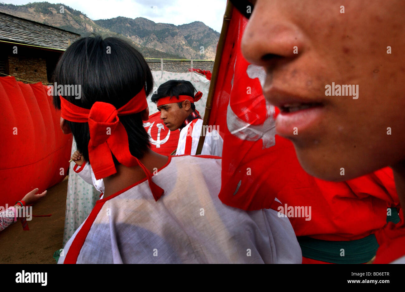 Maoists perform a traditional dance with Communist flags during a ...