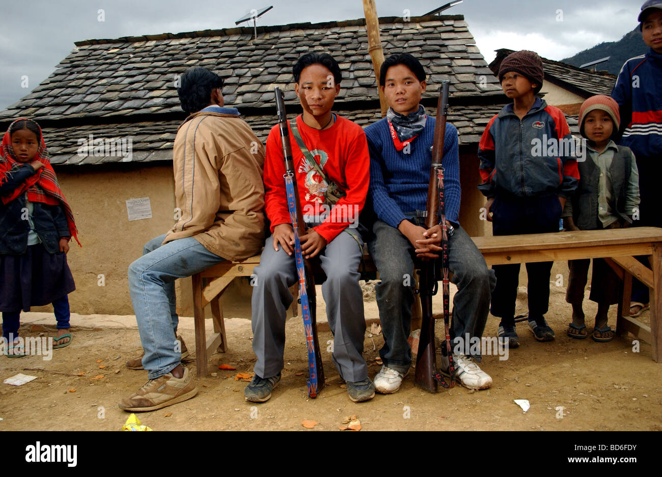 Villagers pose with guns. (Photo by Ami Vitale Stock Photo - Alamy