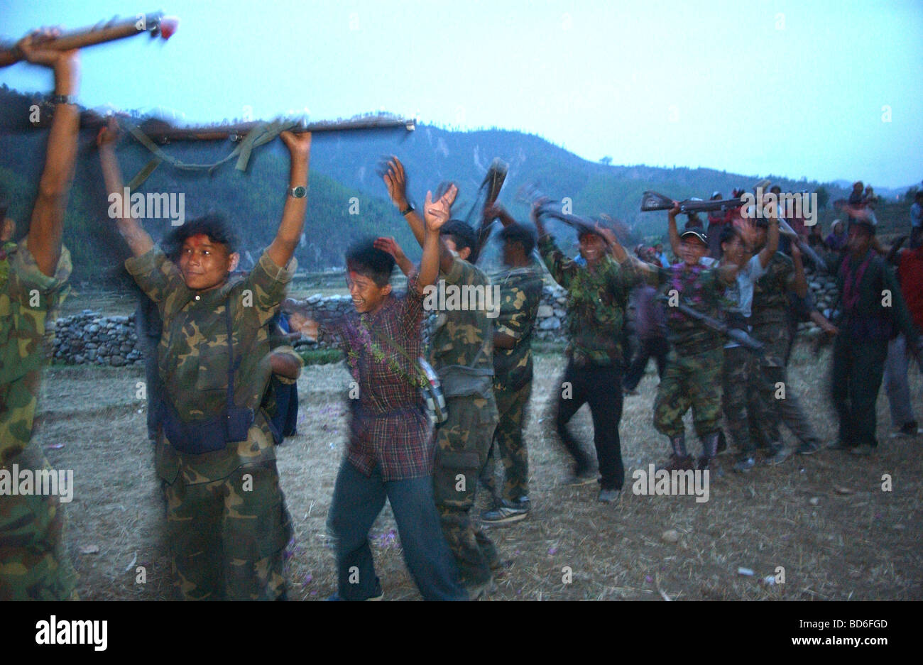 People lift weapons over their heads in celebration. (Photo by Ami ...