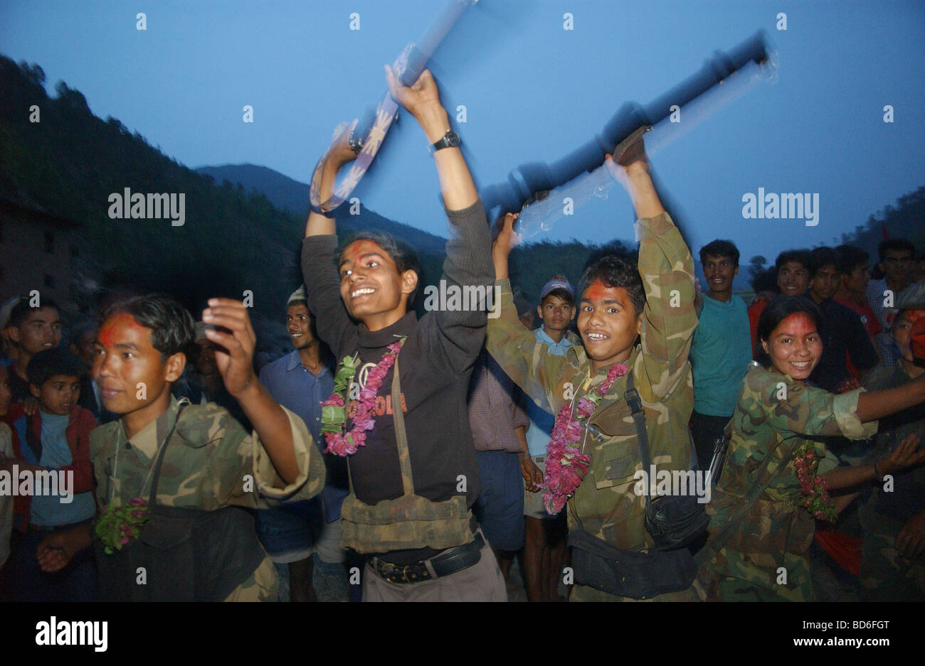 People lift weapons over their heads in celebration. (Photo by Ami ...