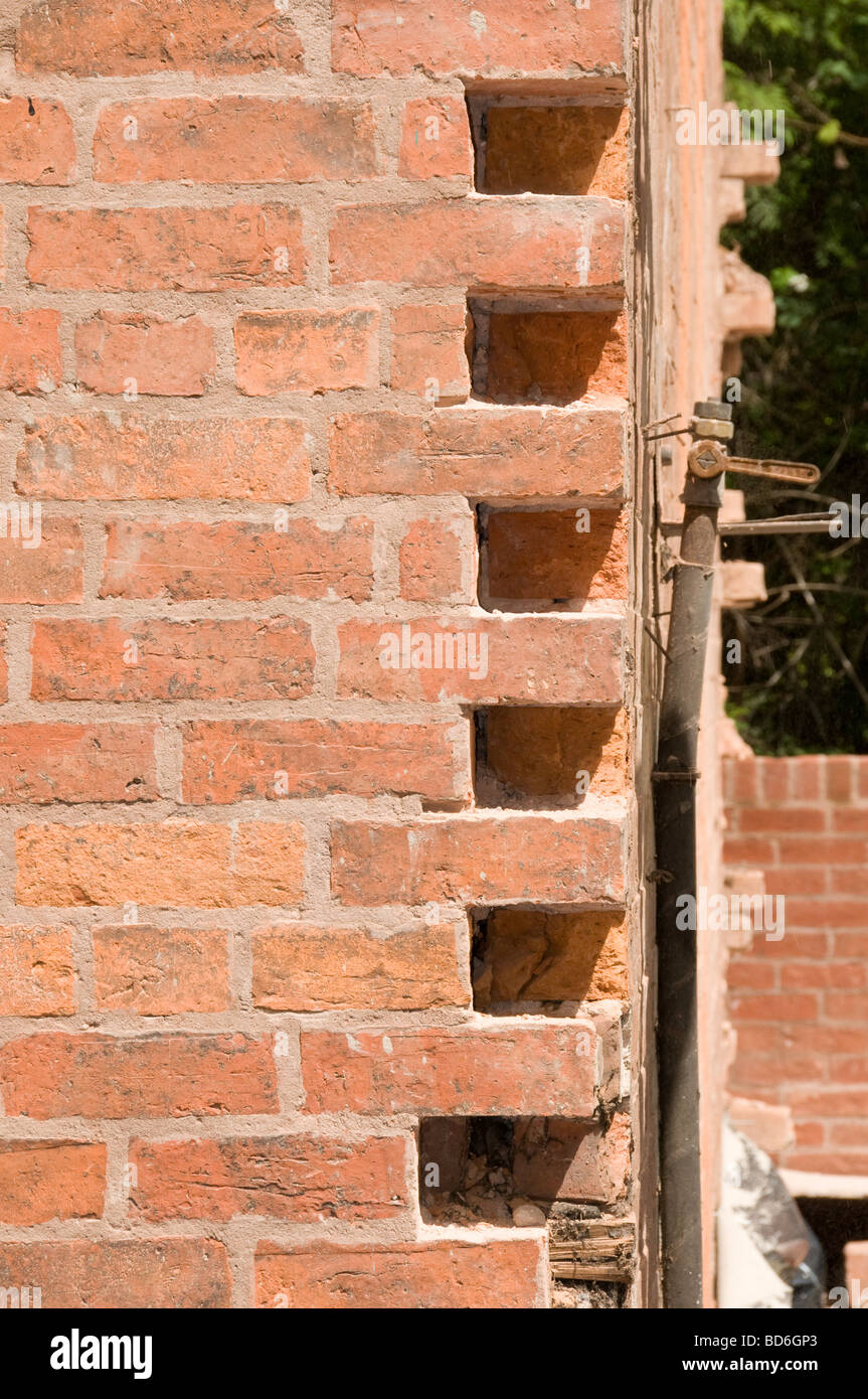 Bricks chopped out of wall in preparation for new extension Stock Photo ...
