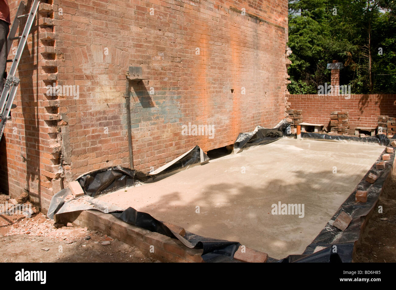 Bricks chopped out of wall and new foundations laid for new extension ...