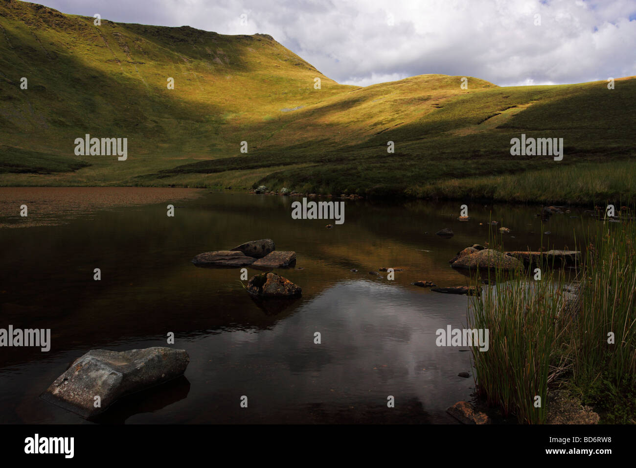 The lake of Llyn Lluncaws, below Cadair Berwyn in the Berwyn mountains ...