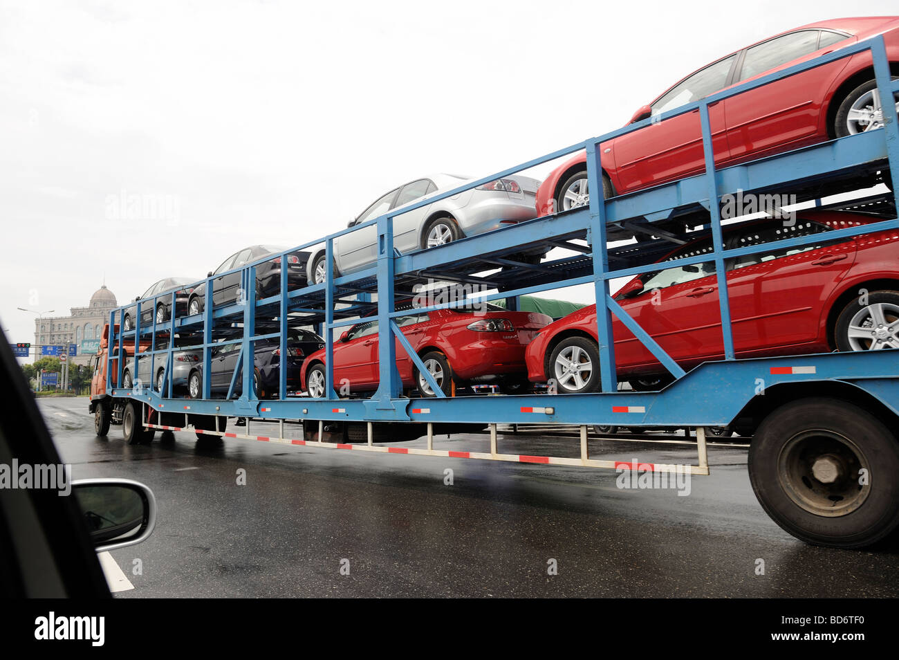 A platform lorry loaded with new cars in Shaoxing, Zhejiang, China. 01 ...