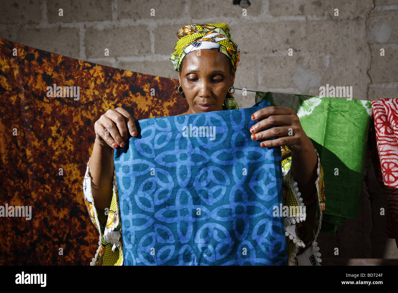 Woman creating batik dyed fabric, working from home, Maroua, Cameroon ...