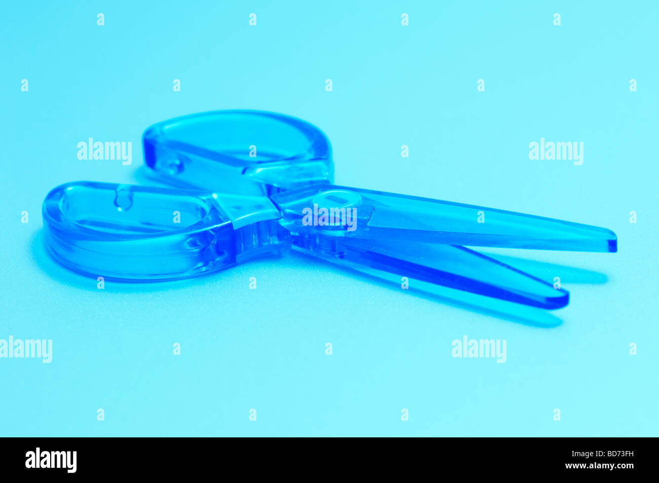 Blue plastic pair of scissors Stock Photo - Alamy