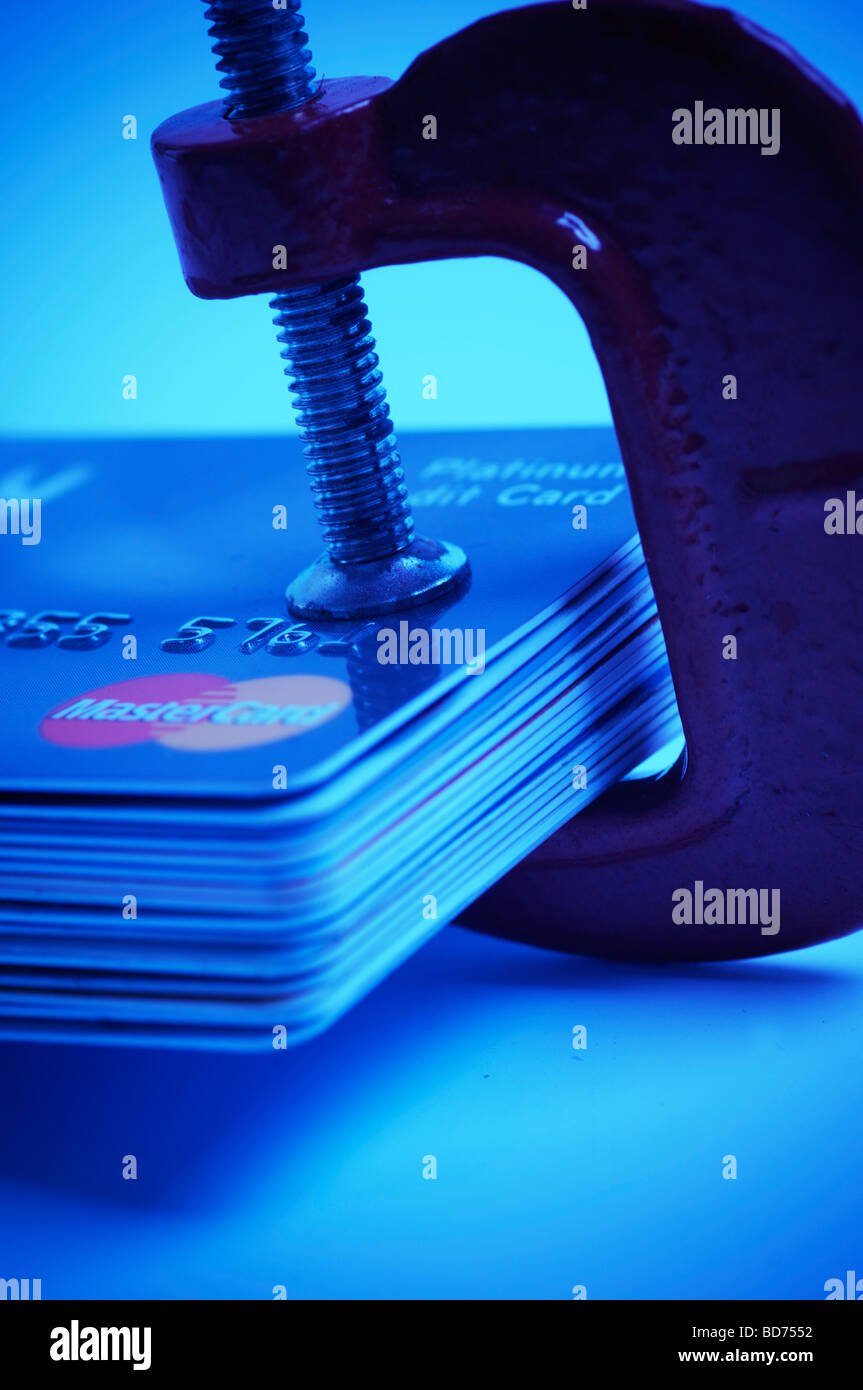 Stack of credit cards squeezed with a metal C clamp Stock Photo - Alamy