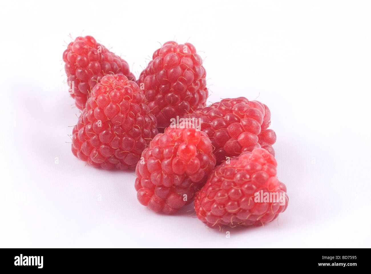Raspberries against white background Stock Photo - Alamy